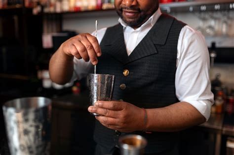Free Photo Bartender Preparing Drink At Bar