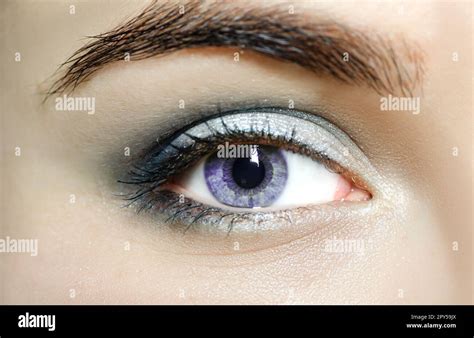 Violet Mutation Eyes Close Up The Human Eye Of A Woman With Light Beauty Cosmetics And Long