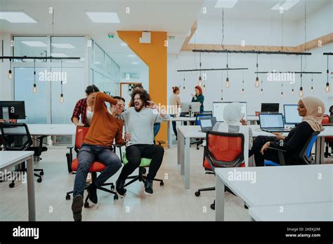 Team Building And Office Fun Young Cheerful Businesspeople In Smart