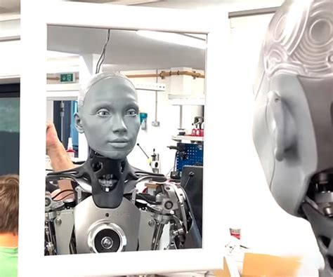Ameca Robot Looks At Herself In A Mirror And Likes What She Sees