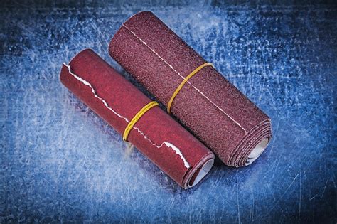 Premium Photo Rolled Up Glass Paper On Metallic Background Abrasive