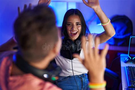 Man And Woman Streamer Playing Video Game With Winner Expression At Gaming Room Stock Image