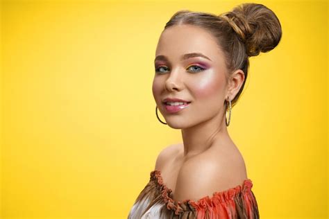 Premium Photo Pretty Girl With Colorful Makeup Posing On Yellow
