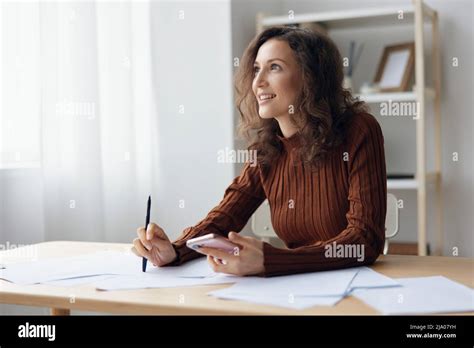 Enjoyed Laughing Happy Cheerful Curly Cute Lady Sitting At Table With