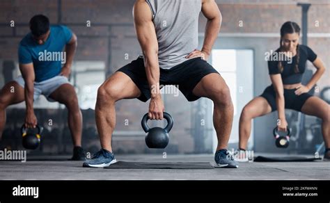 Fitness class, exercise and gym group with kettlebell for a workout and training for health and ...
