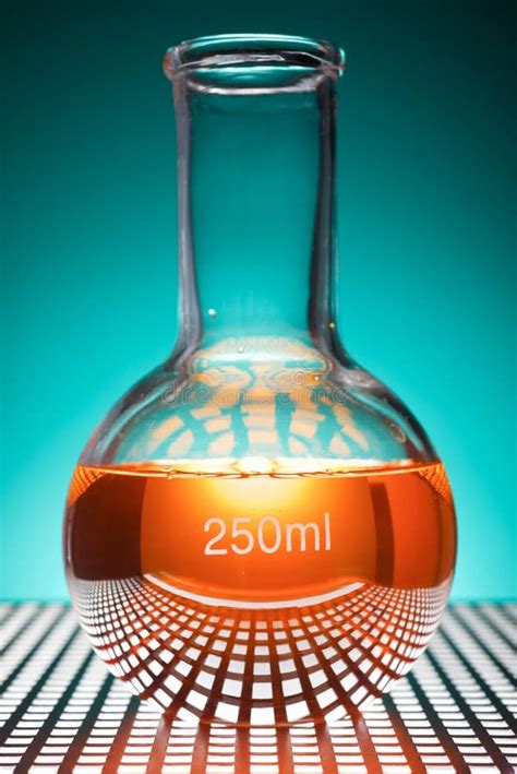 Spherical Glass Flask Placed In A Laboratory Table With Orange Liquid