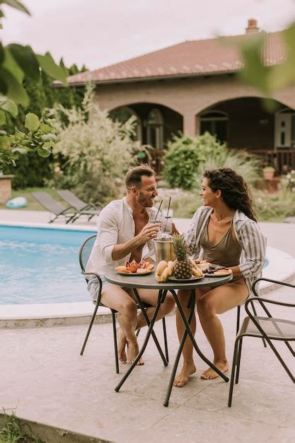 Premium Photo Young Couple Sitting In The Backyard