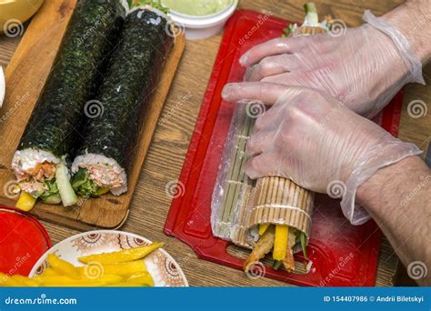 Process Of Making Sushi And Rolls Close Up Of Man Chef Hands Preparing
