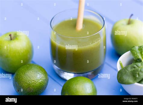 Healthy Green Smoothie Drink With Straw On Blue Table Background Stock