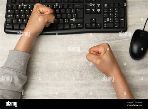 Angry Man With Clenched Fists At Table During Work Top View Stock