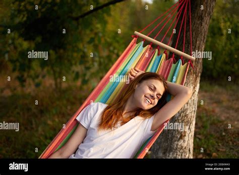 Happy Woman Lies In A Hammock Outdoors In The Forest Laughing Smile