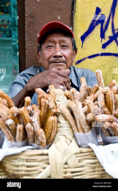 Man Selling Churros On A Street Corner In Puebla Mexico Tasting A