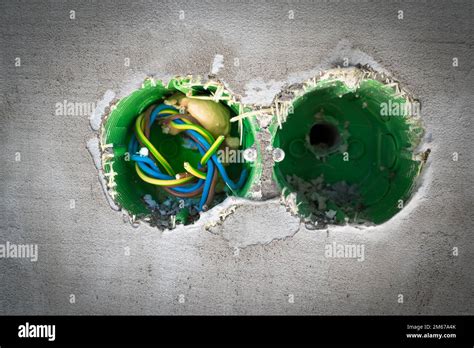 Multi Colored Wires In A Green Socket Under The Socket On The Facade Of