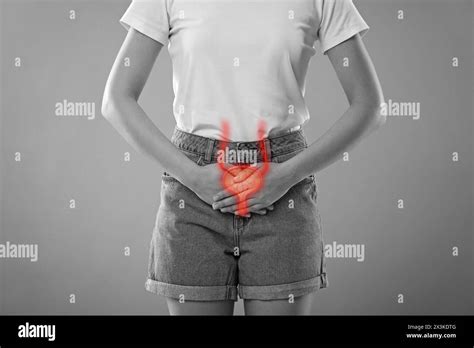 Woman Suffering From Cystitis On Light Grey Background Closeup