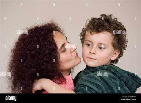 Mother Kissing Her Son Indoor Scene Stock Photo Alamy