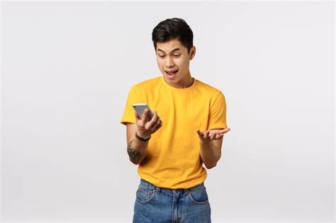 Premium Photo Handsome Young Asian Man In Yellow T Shirt Holding
