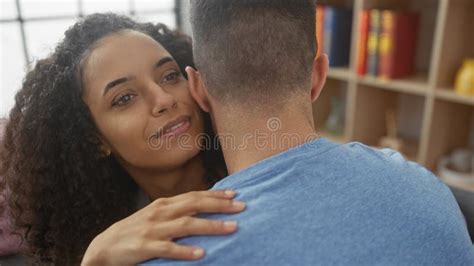 A Woman Embraces A Man From Behind In A Cozy Living Room Depicting