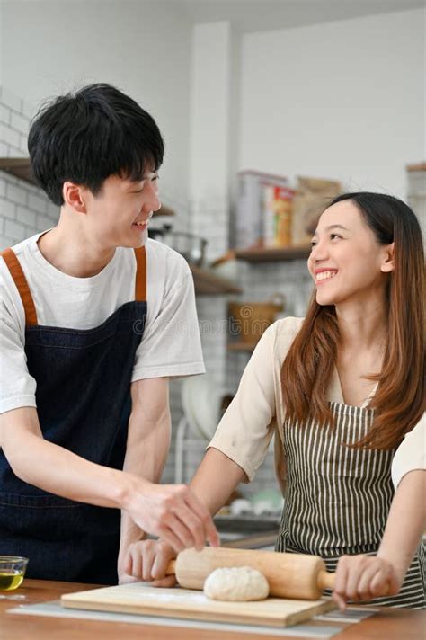 Lovely Asian Couple Enjoy Making Homemade Pastry In The Kitchen
