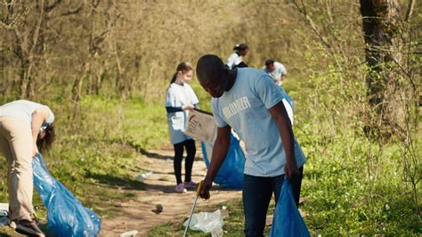 African American Man Volunteer Collecting Trash And Plastic Waste With