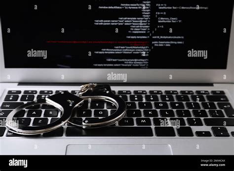 Handcuffs On Modern Laptop Closeup Cyber Crime Stock Photo Alamy
