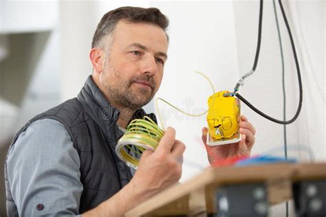 Electrician Checking Socket Voltage Using Multimeter Stock Image