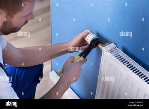 Repairman Fixing Radiator With Wrench Stock Photo Alamy