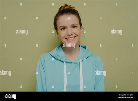 Attractive Teen Girl In Urban Hoodie Hair In Bun Smiling With