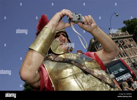 Man In Roman Costume Taking A Photograph For Tourist Cameras Near Colosseum Rome Italy Stock
