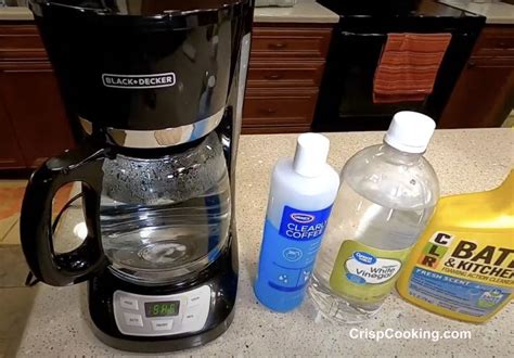 The Coffee Maker Is Sitting On The Counter Next To Its Bottles And