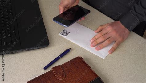 QR Code An Envelope A Man Scans Qr Code Label For Tracking A Delivery Stock Photo Adobe Stock