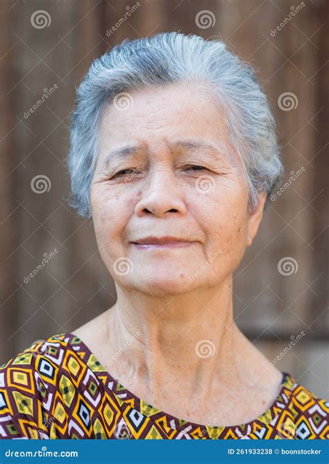 Senior Woman With Short Gray Hair And Looking At The Camera With A