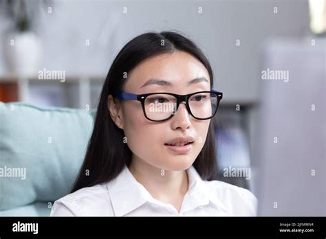 Close-up photo portrait of a young Asian woman office worker, wearing ...