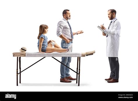 Father And Daughter With Knee Injury At A Hospital Talking To A Doctor