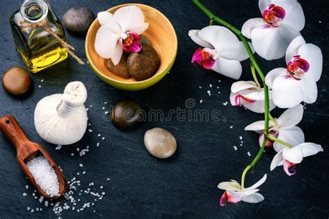 Spa Setting With White Orchid Herbal Massage Ball And Essential Stock