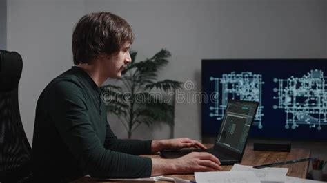 A Man Is Seated At A Desk Using A Laptop Computer As An Output Device Stock Video Video Of