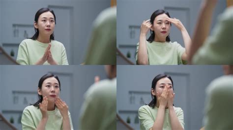 年轻美丽的韩国女性在家里的浴室里使用镜子和涂抹保湿面霜。年轻的亚洲女性花时间在护肤和恢复健康上视频素材下载编号25565908光厂