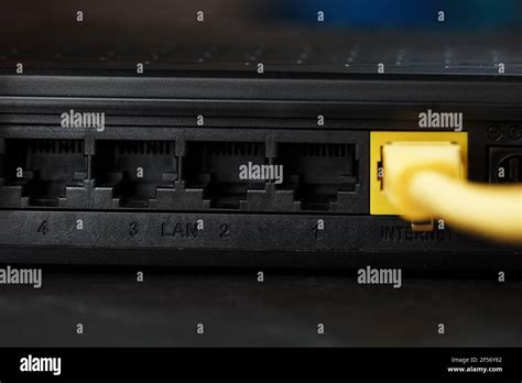 Wireless Modem Router With Yellow Cable And Lan Port For Connection On A Black Background