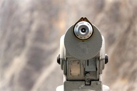 Premium Photo Close Up Of Coin Operated Binoculars Against Blurred