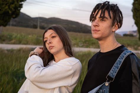 Happy Young Couple Dressed Casual In A Sunset Girl And Guy Kissing