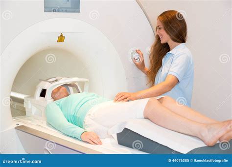 Medical Technical Assistant Preparing Scan Of Patient S Head With Mri