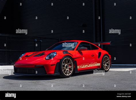 A Stunning Guards Red 992 Porsche Gt3 Rs With Aurum Gold Wheels Stock