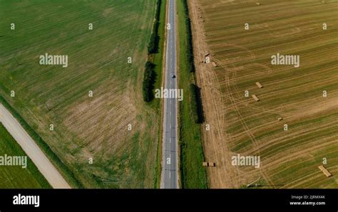 Aerial View Of Straight Road With Car Between Agricultural Fields View