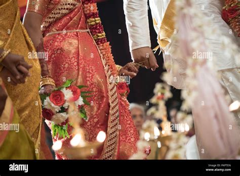 Bride And Groom Linking Pinky Fingers At Indian Hindu Wedding Ceremony