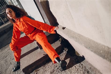 Premium Photo Young Brunette Curly Woman In Orange Suit Female In