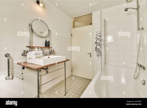 Glass Partition Between Shower Tap And Wall Flush Toilet In Barhroom At