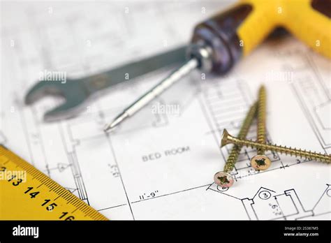 Spanner Screws And Other Repair Tools On Blueprints Of Residential