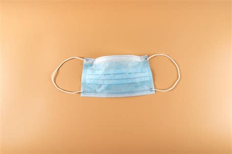 Premium Photo Close Up Of Surgery Mask Against Orange Background