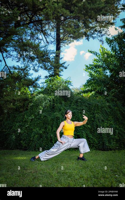 Woman Practicing Tai Chi Quan In The Park Tai Chi Is A Physical And Mental Practice Originating