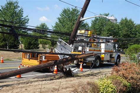 Electric Utility Repair Crew On The Scene Of A Broken Wooden Utility