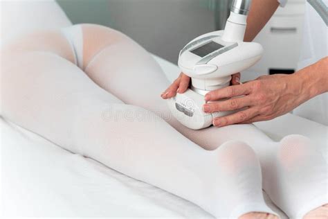 Woman In Special White Suit Getting Anti Cellulite Massage For Legs In A Spa Salon Lpg And